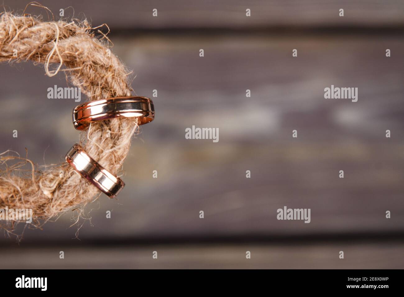 Wedding rings on the thread close-up Stock Photo - Alamy