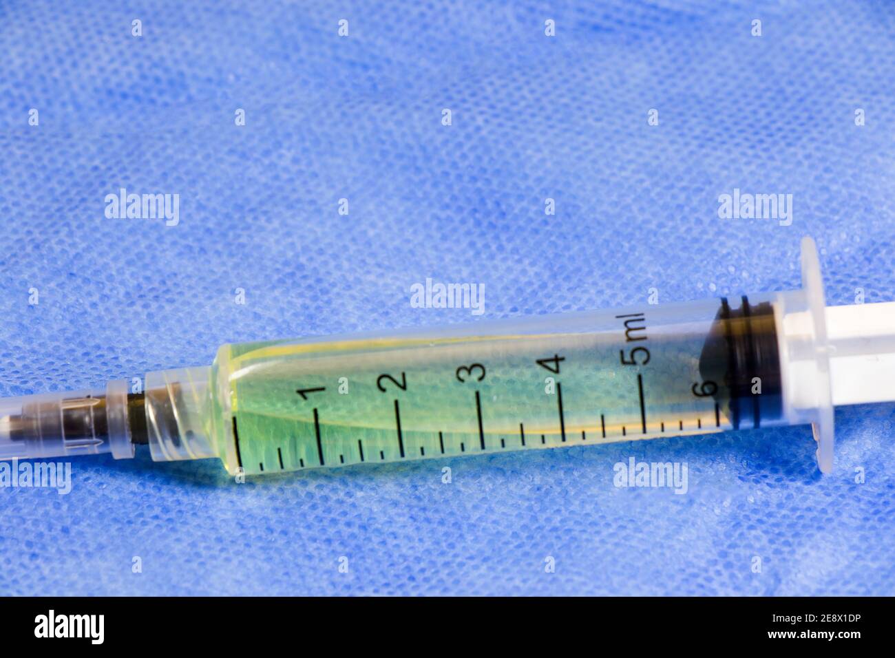 High angle shot of syringe with liquid vaccine on sterile table Stock ...