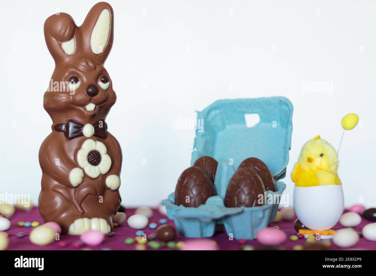 Chocolate bunny, egg carton with chocolate eggs and decorative chick ...