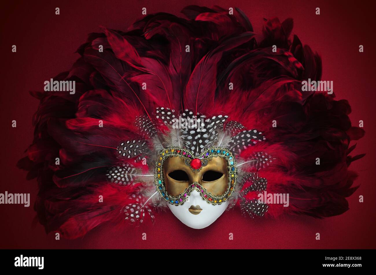 Red carnival mask with feathers Stock Photo - Alamy