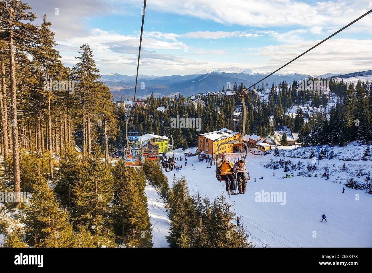 03.01.2021- Dragobrat, Ukraine. Skiers and skateborders on the mountain ...