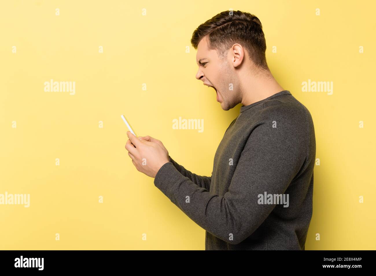 Side profile young man screaming hi-res stock photography and images ...