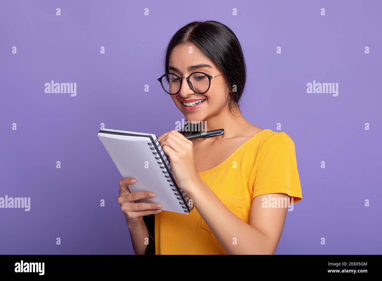 Woman thinking writing in book hi-res stock photography and images - Alamy