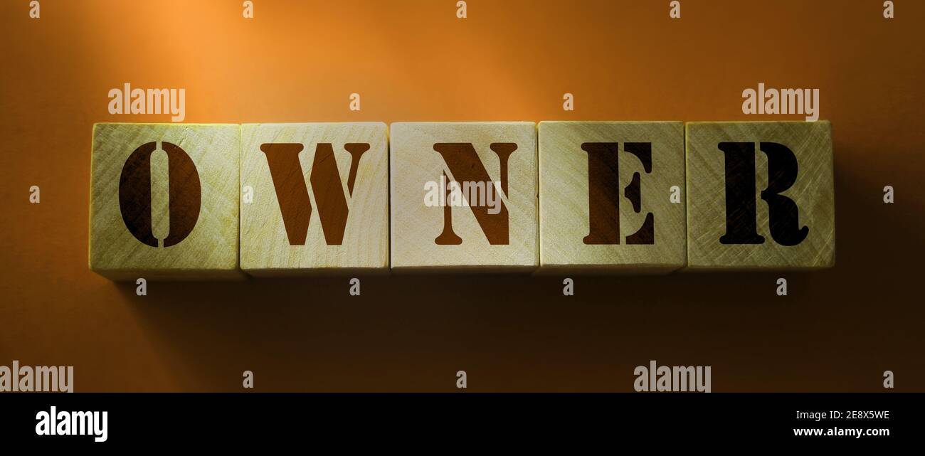 Owner word on wooden blocks on red. Ownership business concept Stock ...