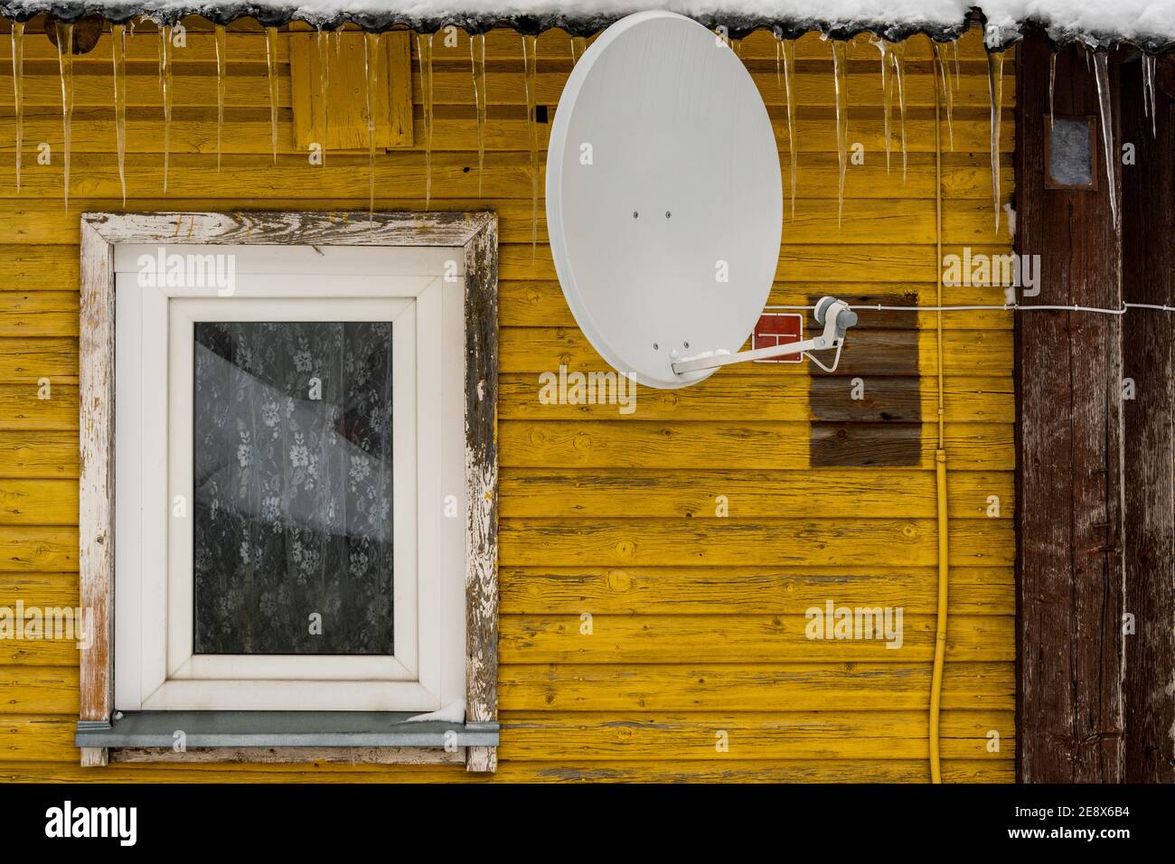 Satellite dish and window on the old wooden house Stock Photo - Alamy