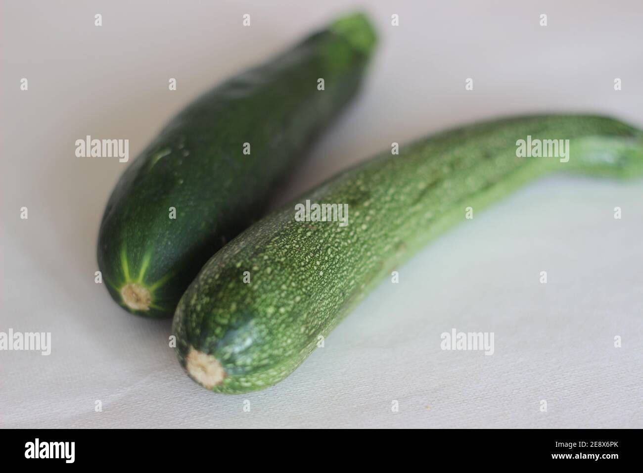 The zucchini courgette or baby marrow photographed on white background ...