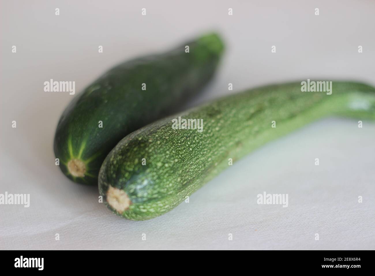 The zucchini courgette or baby marrow photographed on white background ...