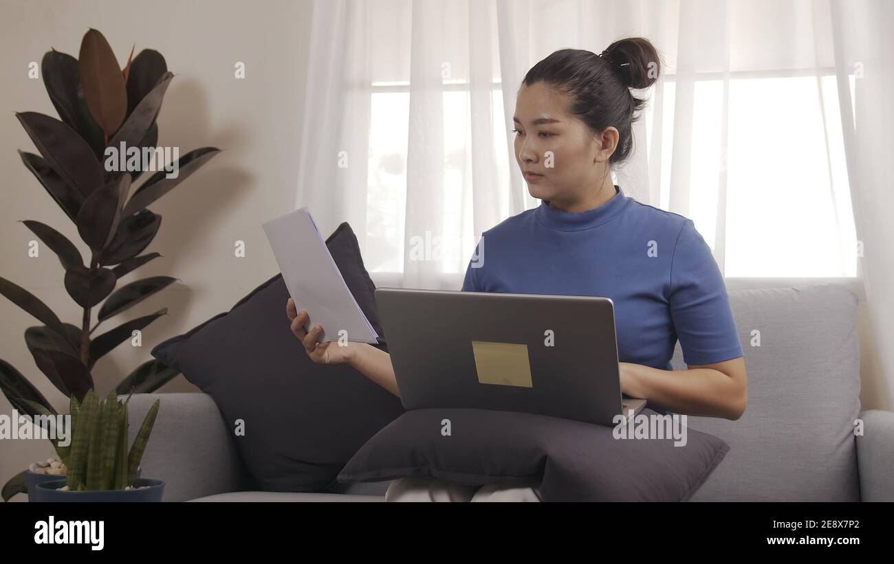 New normal businesswoman work from home by laptop sitting on the sofa ...