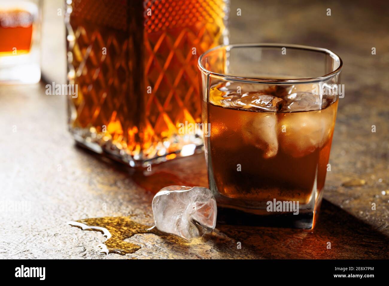 Whiskey in frosted glass with ice. Alcoholic drink with natural ice ...