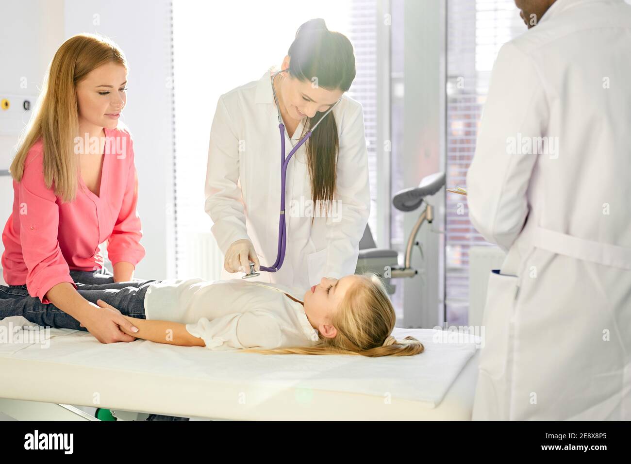 caucasian female doctor check the heartbeat of patient child with ...