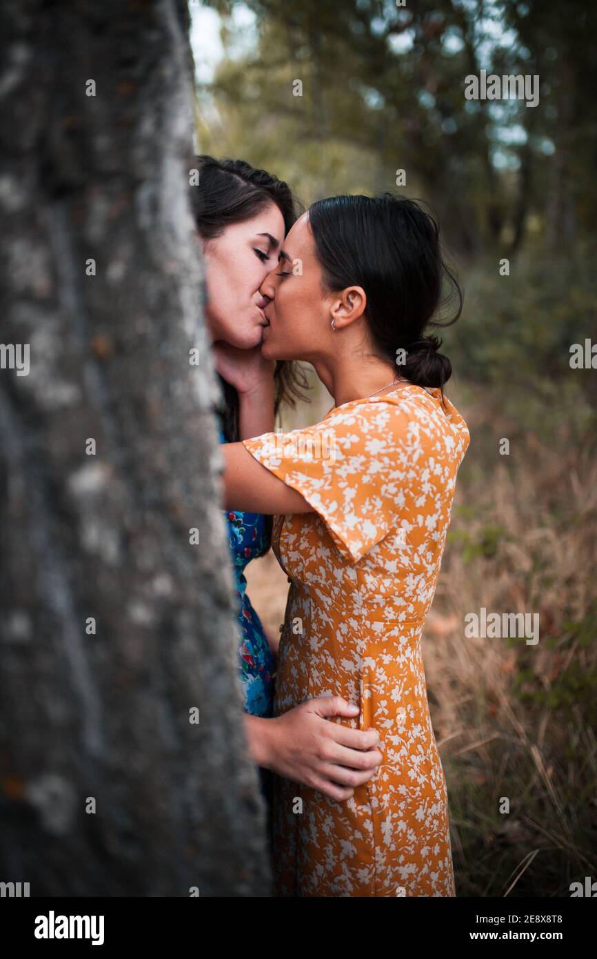 Two young lesbians kissing and caressing each other in the woods Stock Photo - Alamy