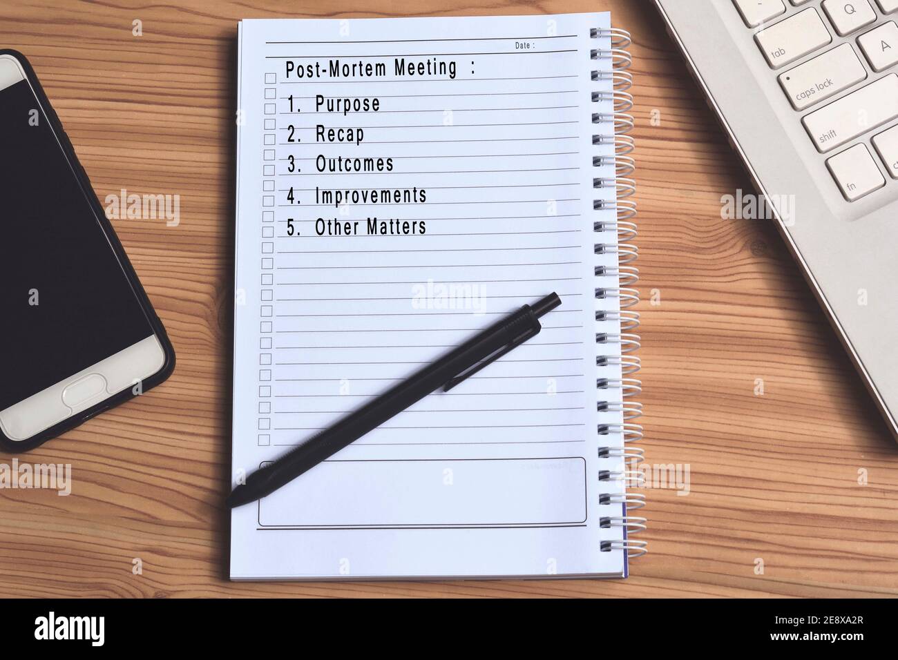 Text label on notepad with laptop and smartphone Stock Photo - Alamy