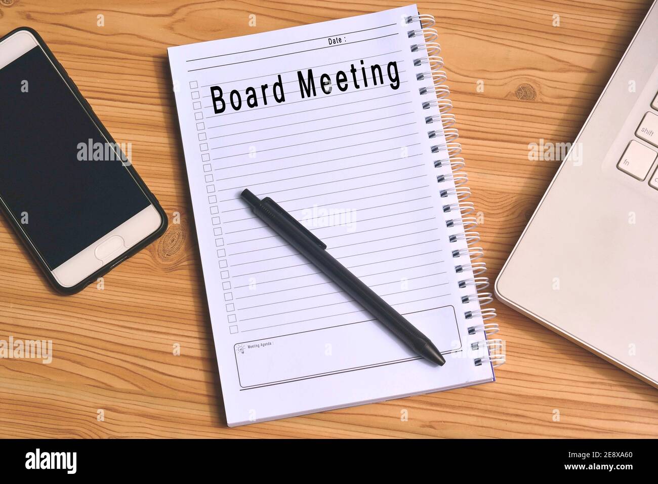 Board Meeting label on notepad with laptop and smartphone Stock Photo ...