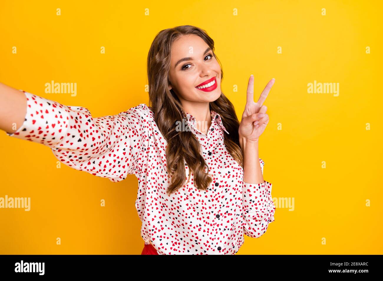 Photo of cute young lady take selfie show v-sign wear heart print shirt ...