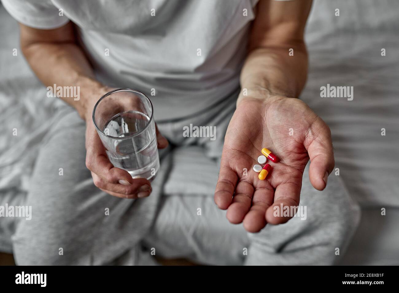 elderly man taking pills, closeup. many pills in hands. caring for the ...