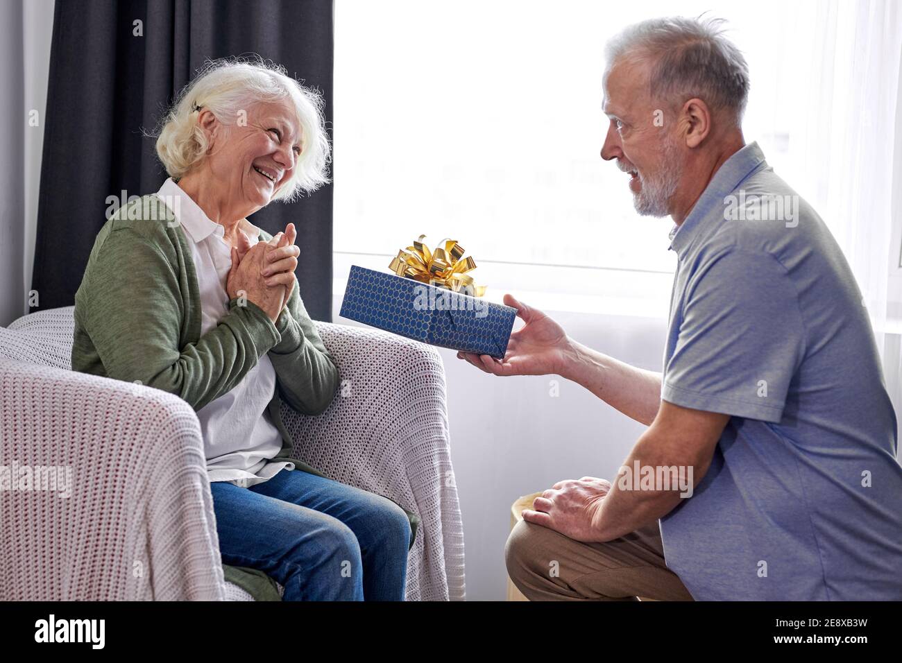 senior husband making surprise giving gift box to nice pretty wife ...