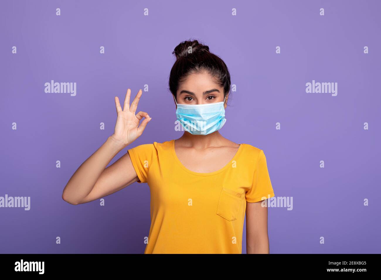 Indian woman in medical mask showing ok sign gesture Stock Photo - Alamy