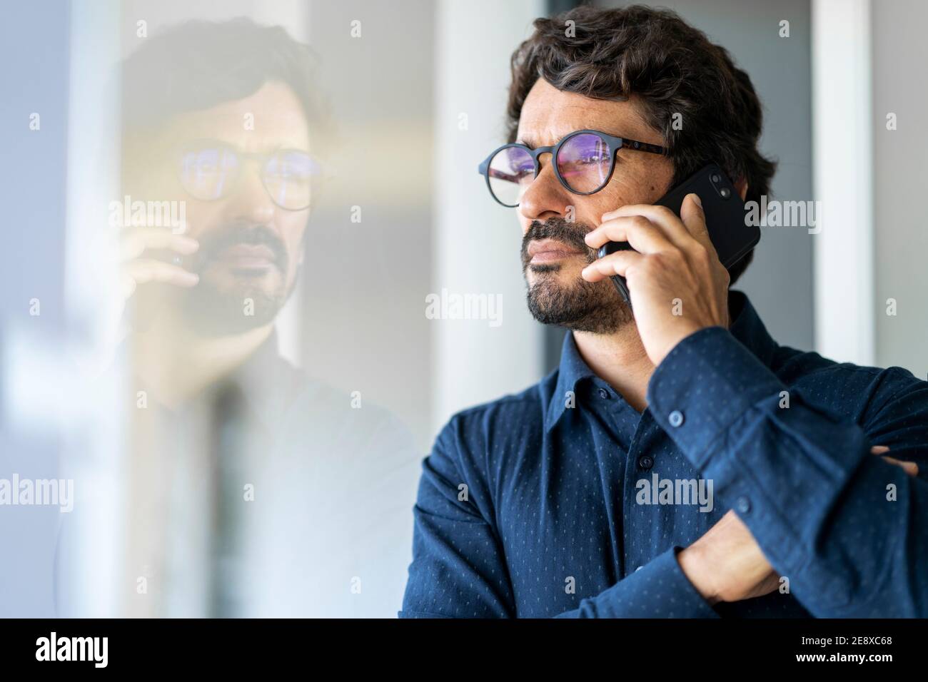 Casual man wearing glasses talking on the phone. Successful male ...