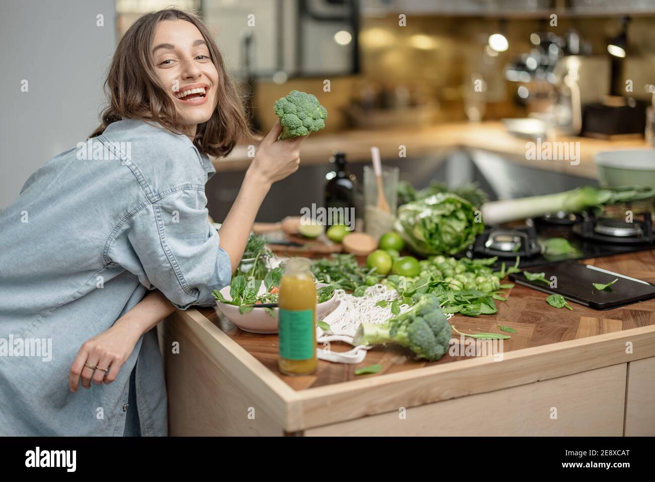 Woman enjoy healthy food on the kitchen Stock Photo - Alamy
