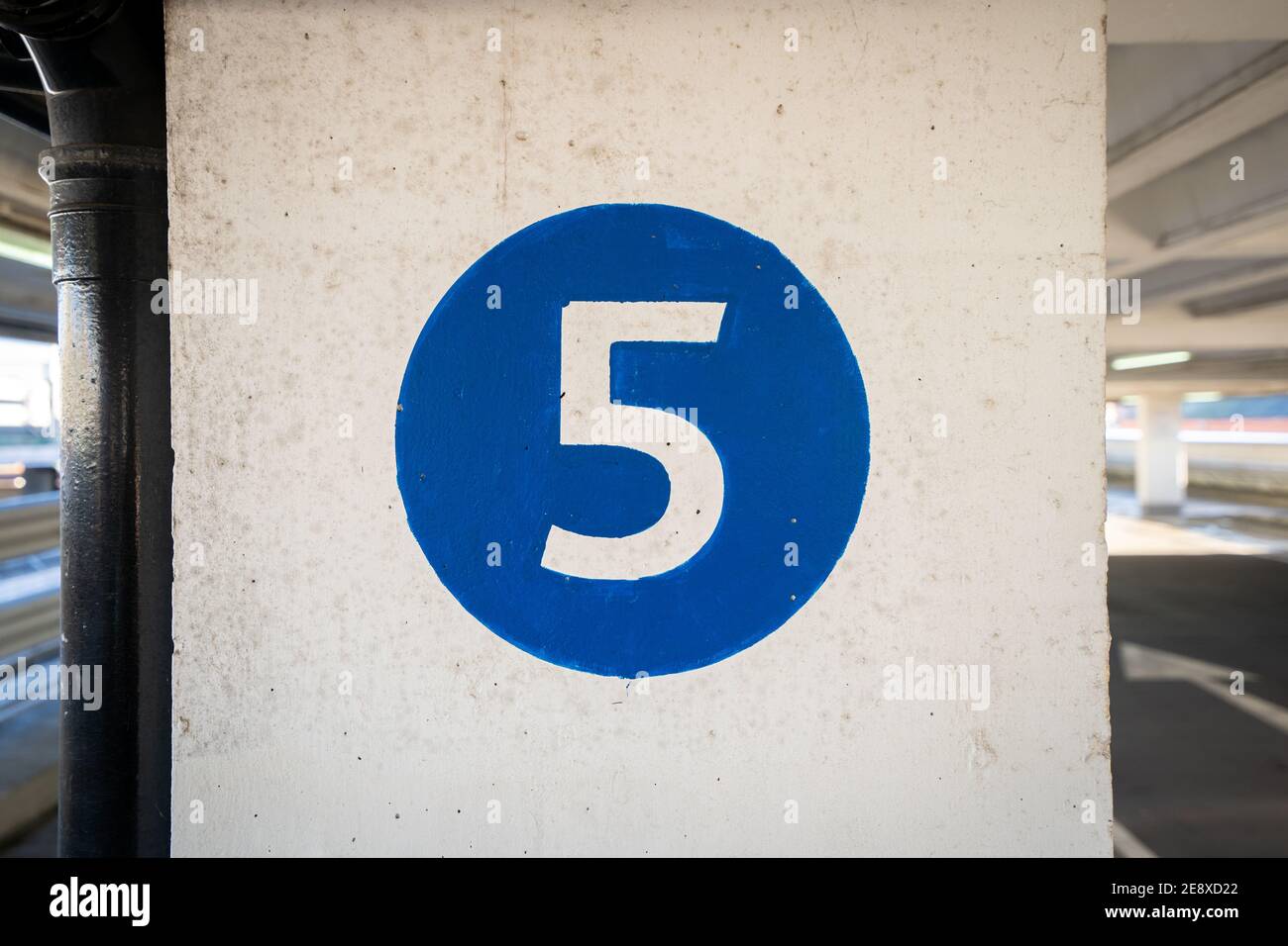 White coloured hand painted level number five in the middle of a blue ...