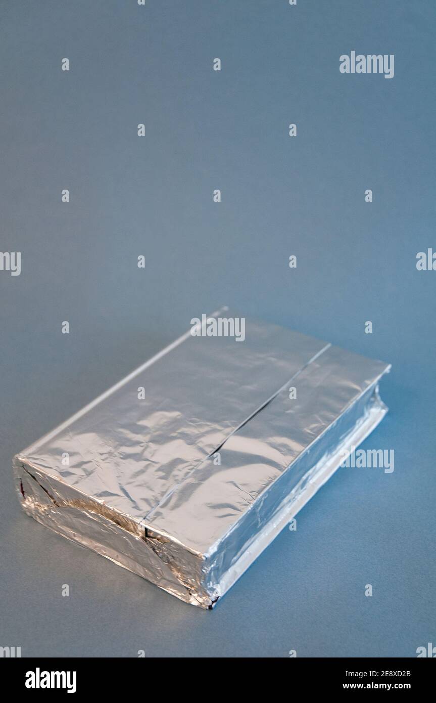 Book wrapped in aluminium foil Stock Photo - Alamy
