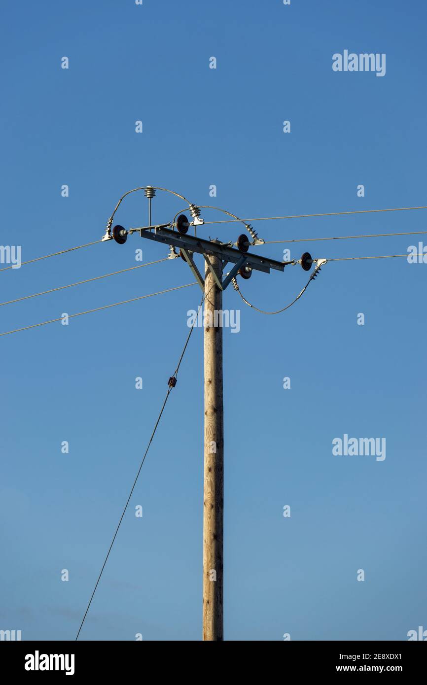 Power cables at top of pole with jumper cables Stock Photo - Alamy