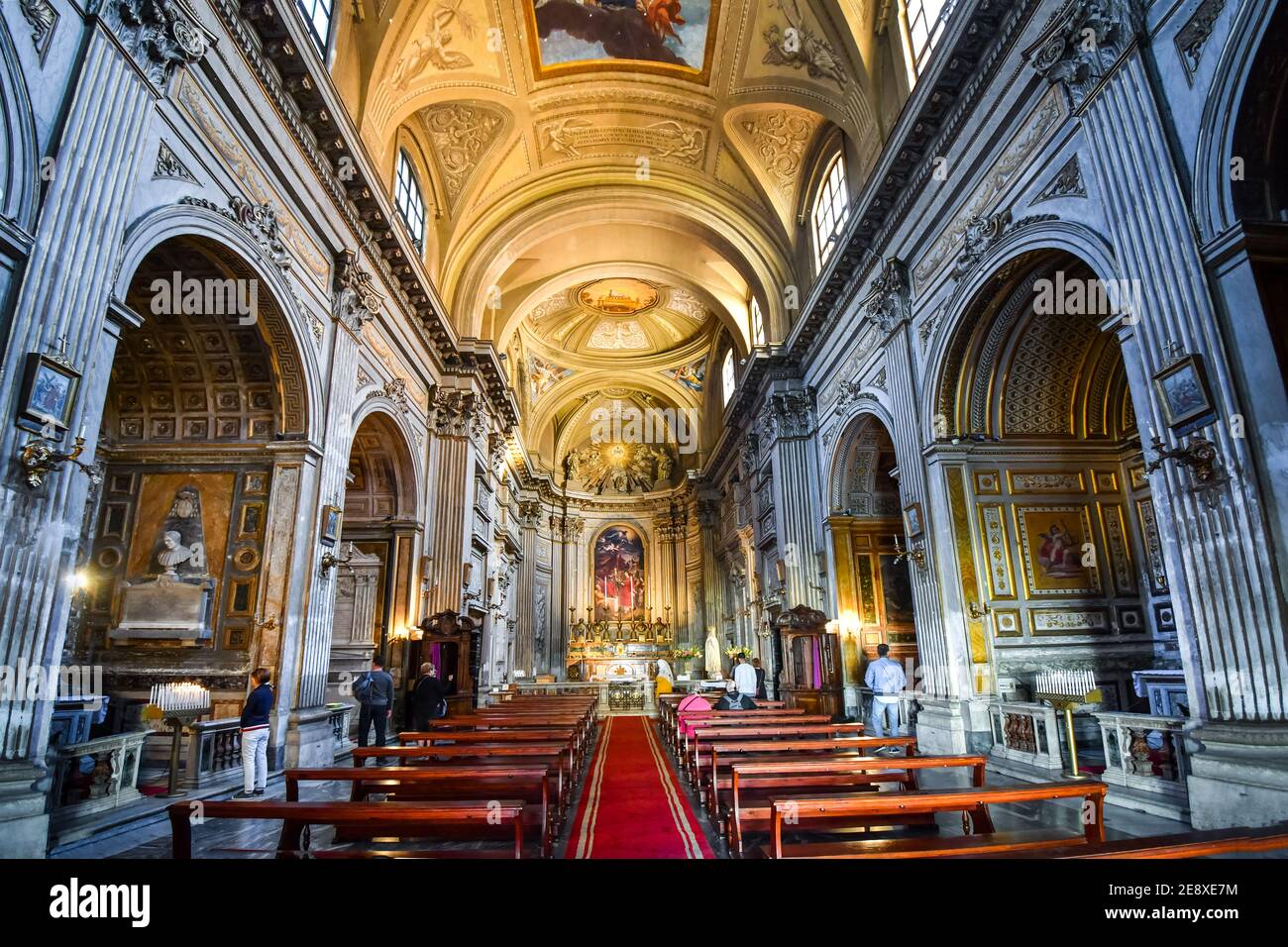 Visitors appreciate the gothic church interior apse, arches and naves ...