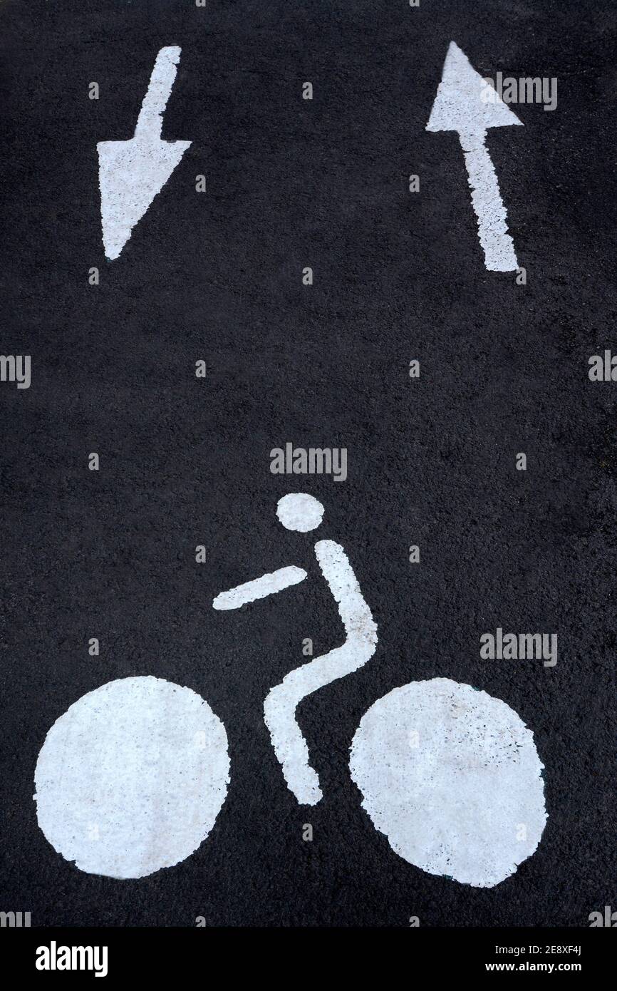 Bicycle lane markings indicating direction for cyclists on a paved ...