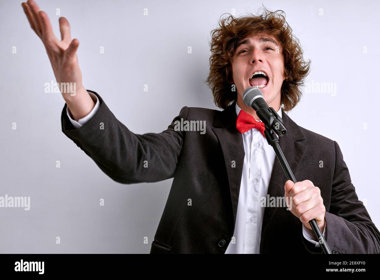 singer man at performance singing on microphone, expressive artist ...