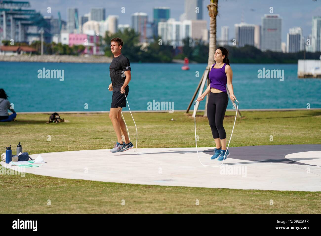Healthy couple jump rope in the park Stock Photo - Alamy