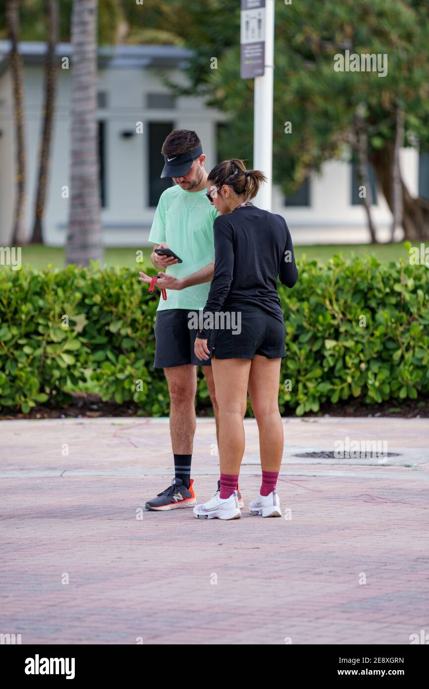 Couple checking sports stats on a fitness watch Stock Photo - Alamy