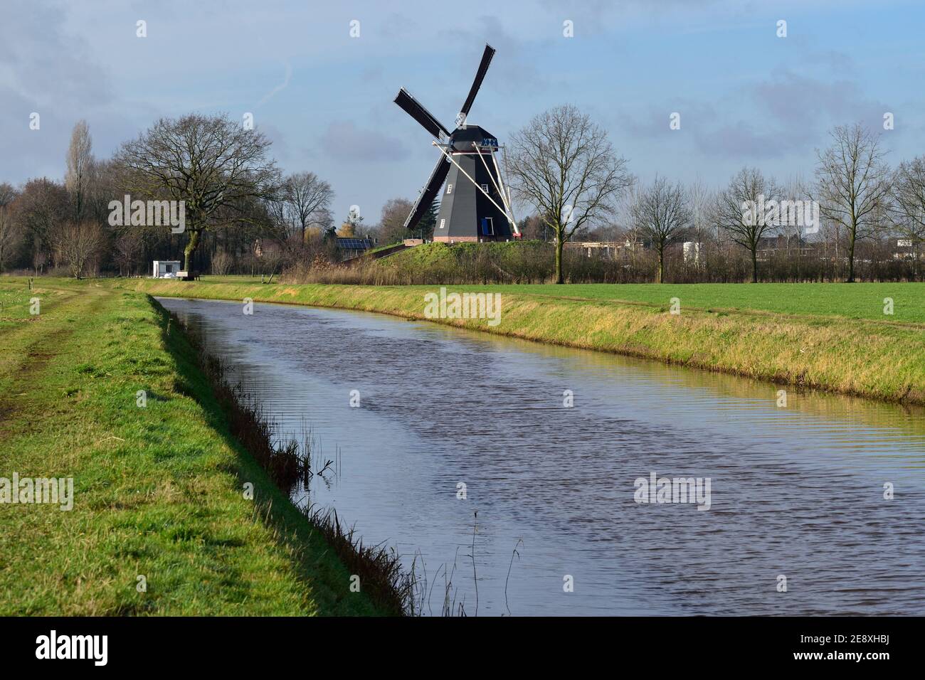 Traditional Dutch windmill overlooking a drainage kinderdijk canal ...