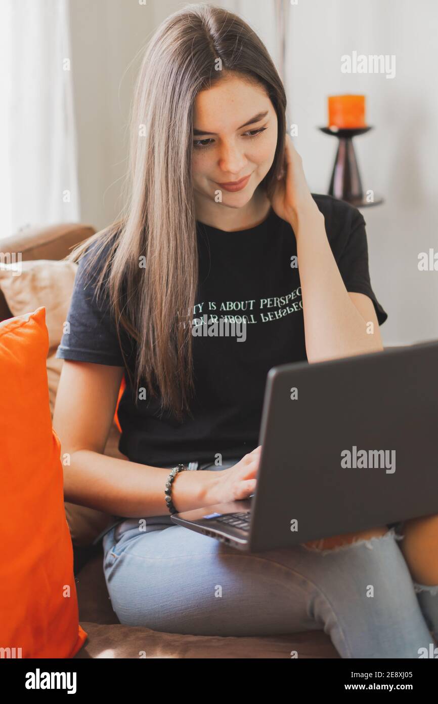 Young woman with her laptop. Performing various tasks and meetings ...