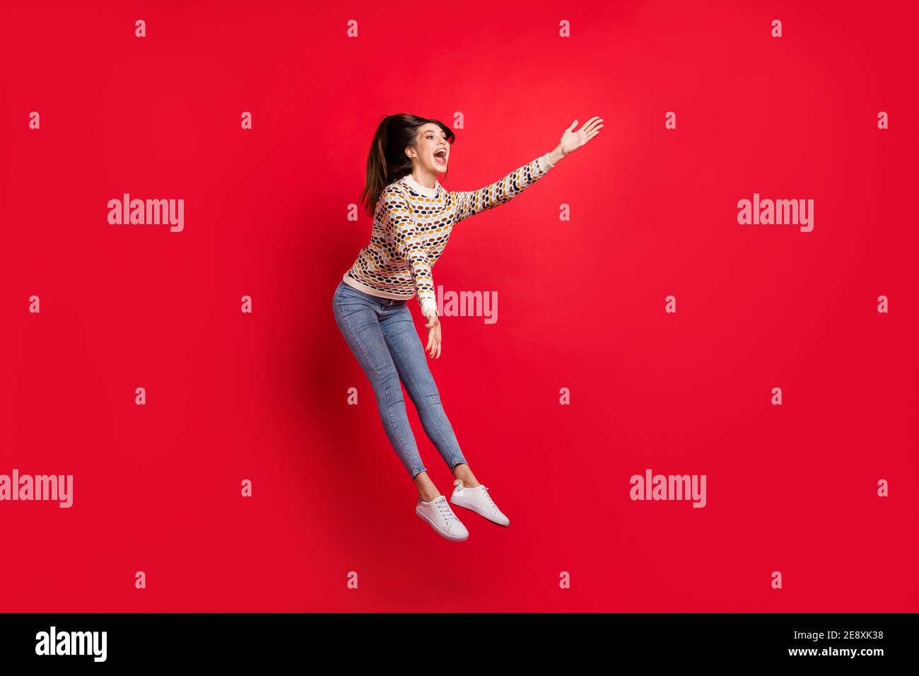 Full length body size photo of girl in sweater jumping blowing wind ...