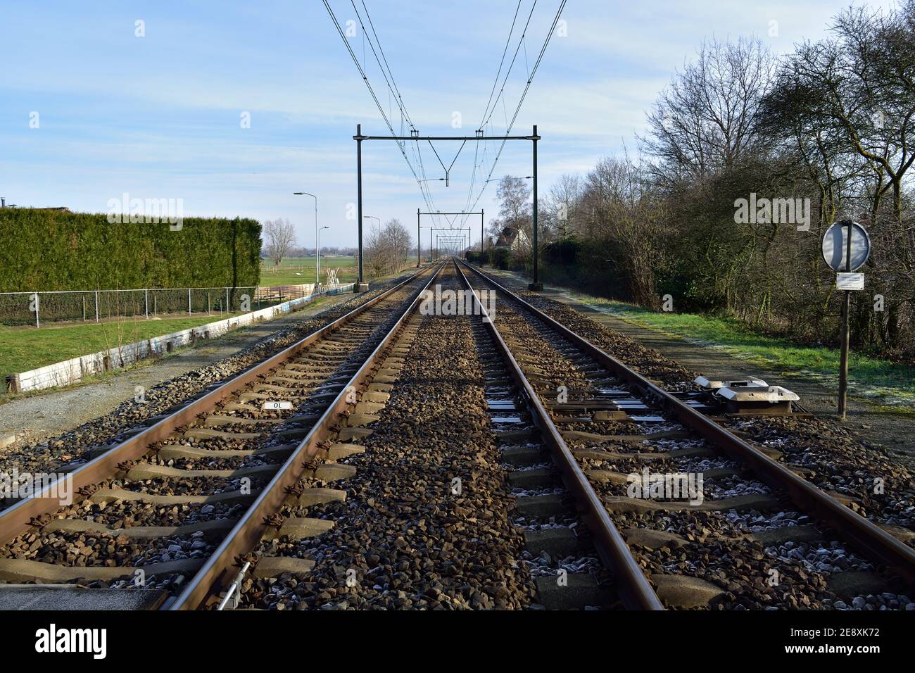 Railroad tracks in the Netherlands countryside fading into a ...