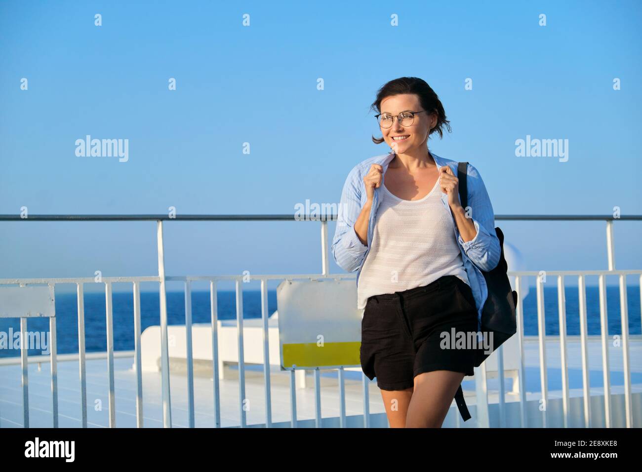 Beautiful happy mature woman on deck of ship, ferry, enjoying sea ...