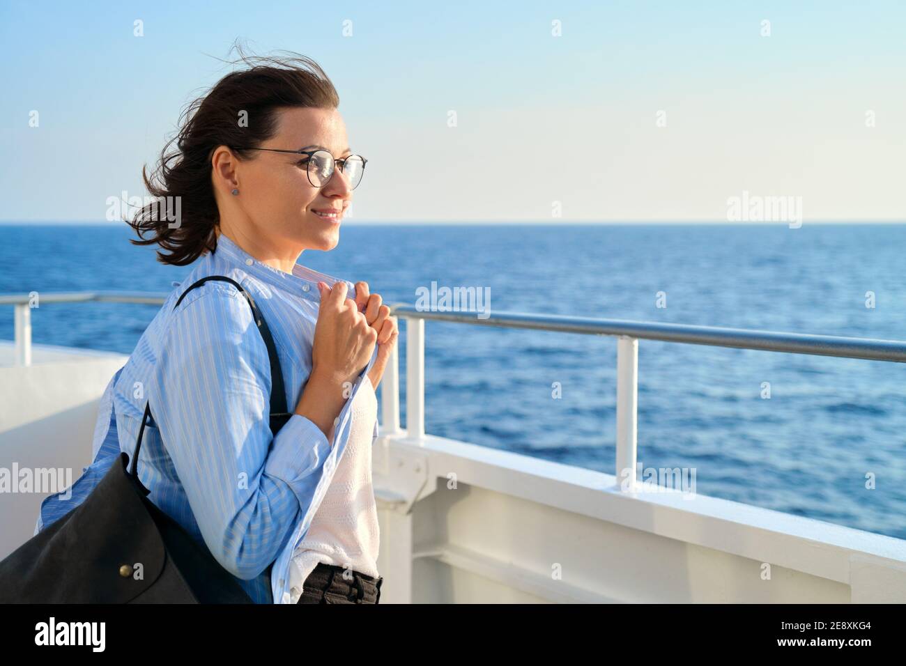Beautiful happy mature woman on deck of ship, ferry, enjoying sea ...