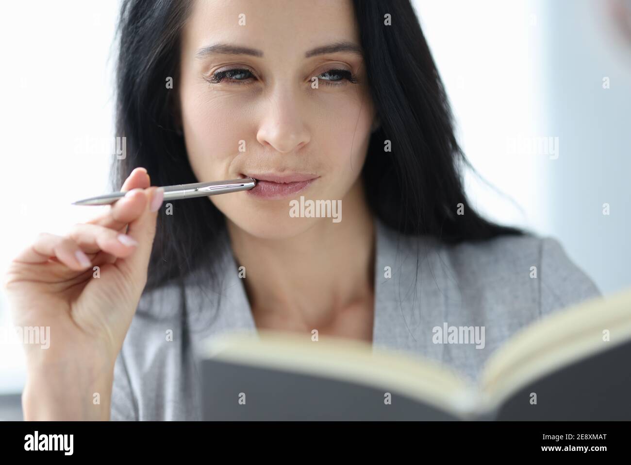Young woman pen in mouth hi-res stock photography and images - Alamy
