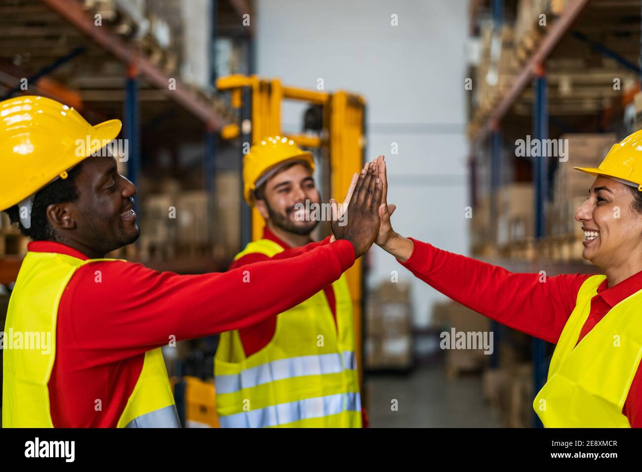 Happy team enjoying working together in delivery warehouse - Logistic ...