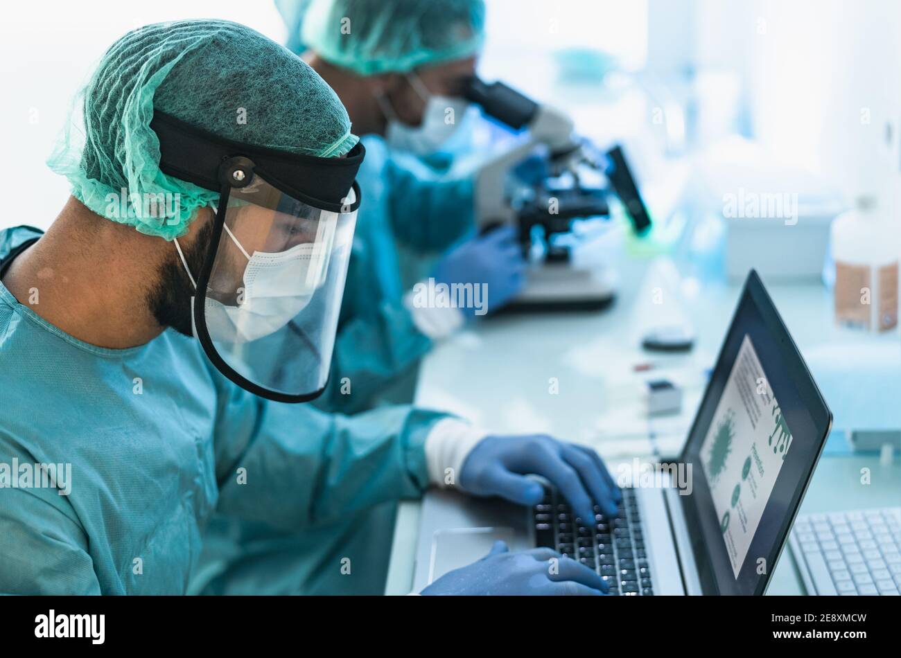 Doctors wearing personal protective equipment working in laboratory ...