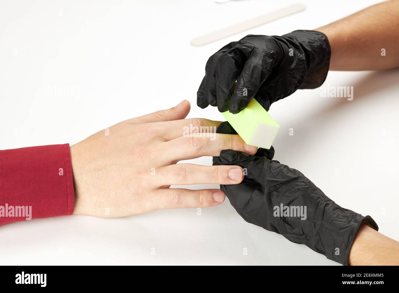 manicurist during work using buff nail. a man manicure process. an ...