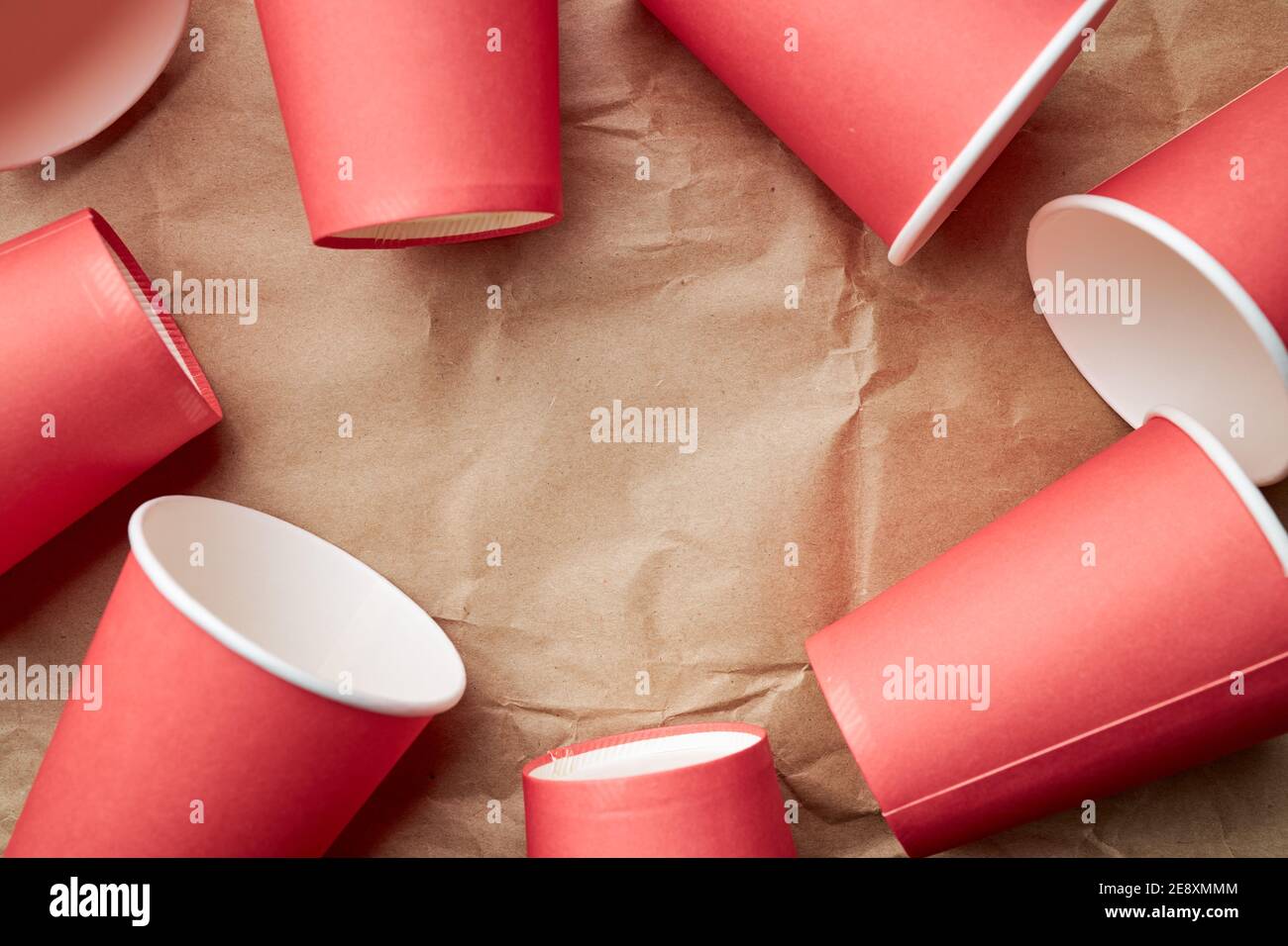 pile of disposable red paper cups on paper background. eco friendly ...