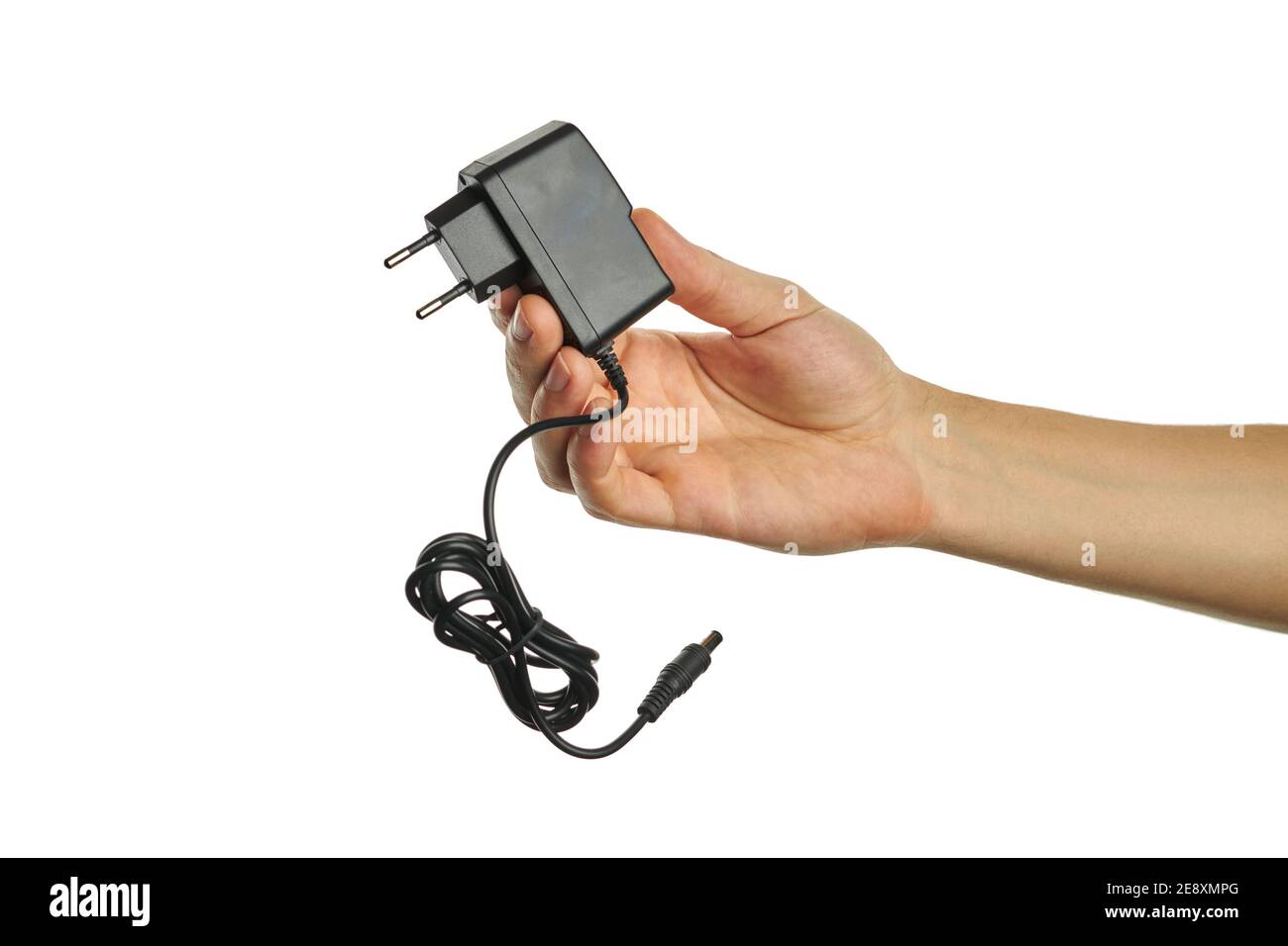 dc power adapter at caucasian persons hand. isolated on a white ...
