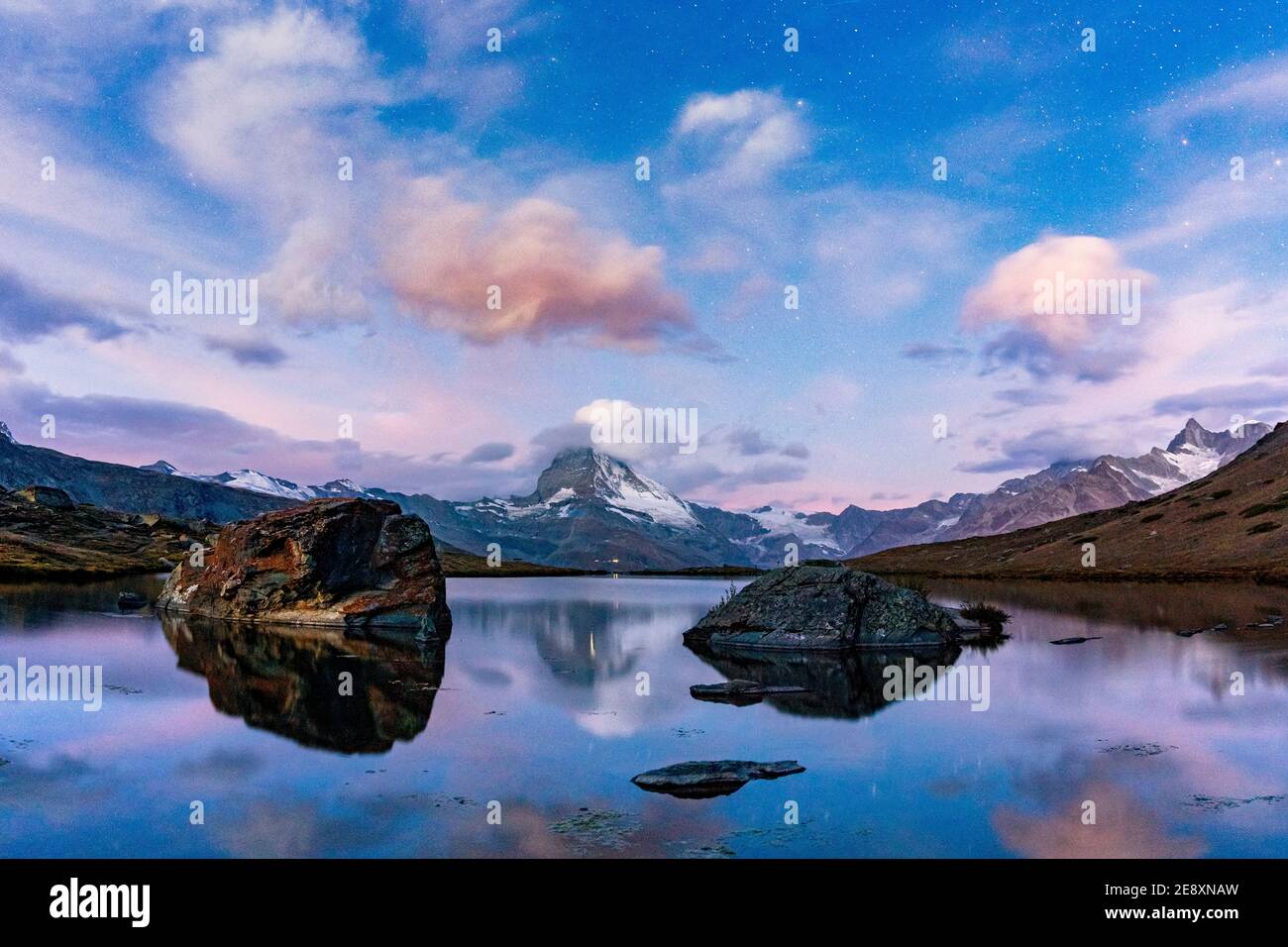 Matterhorn mirrored in the pristine lake Stellisee at dusk, Zermatt ...