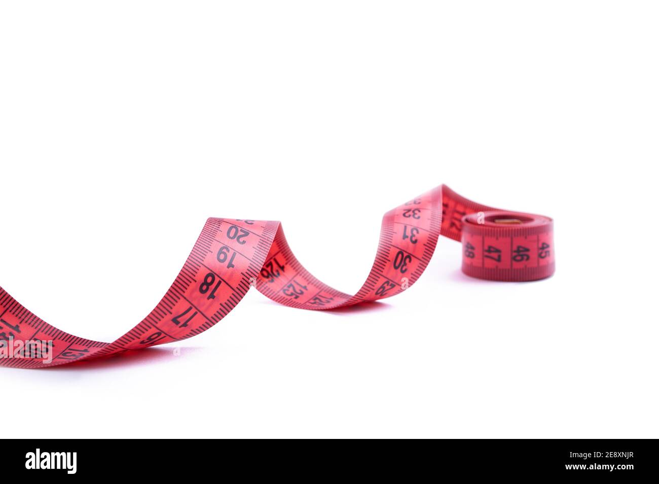 slim concept. red measuring tape isolated on a white background ...