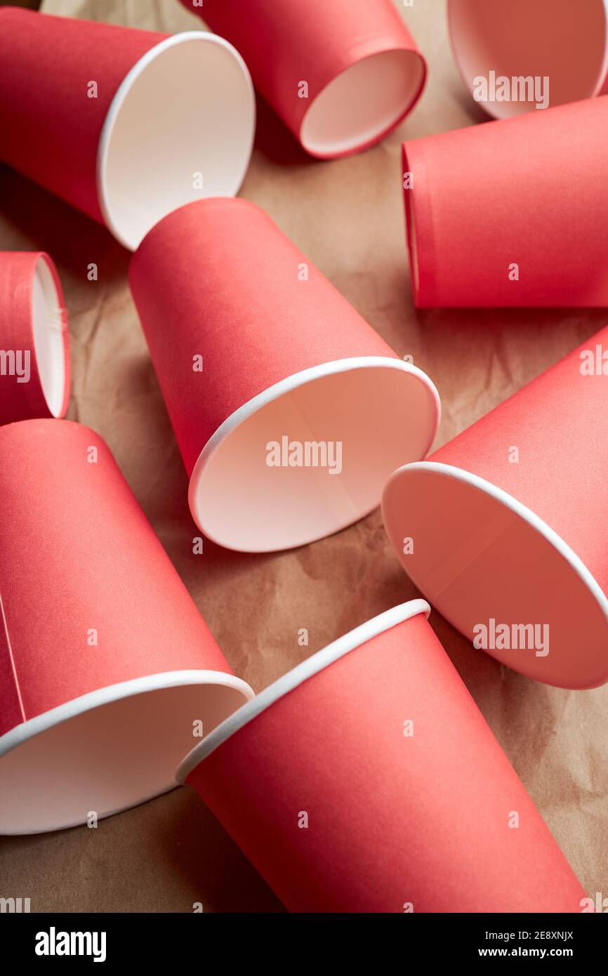 pile of disposable red paper cups on paper background. eco friendly ...