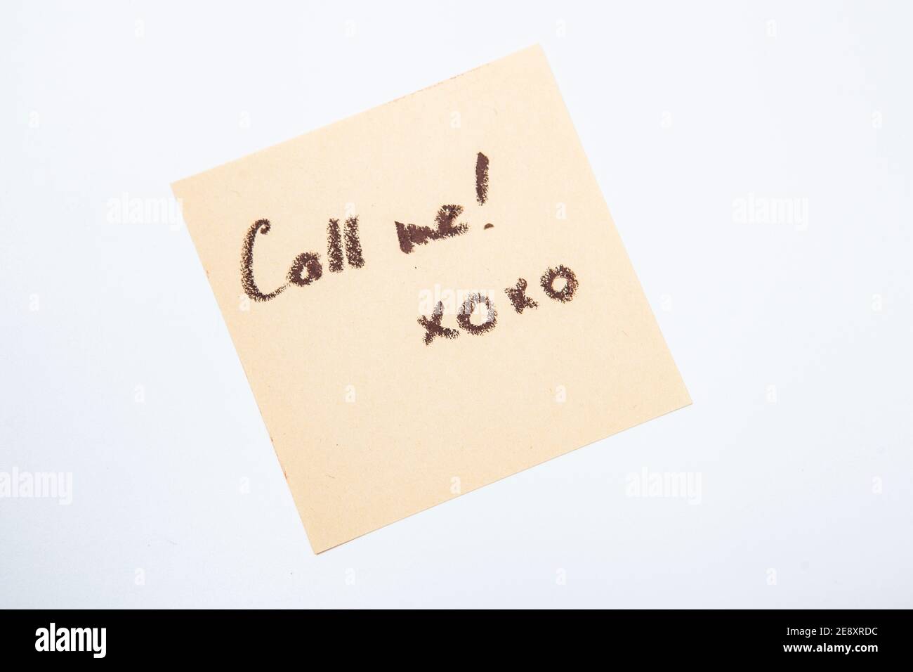 Yellow sticky note with handwritten call me memo Stock Photo - Alamy