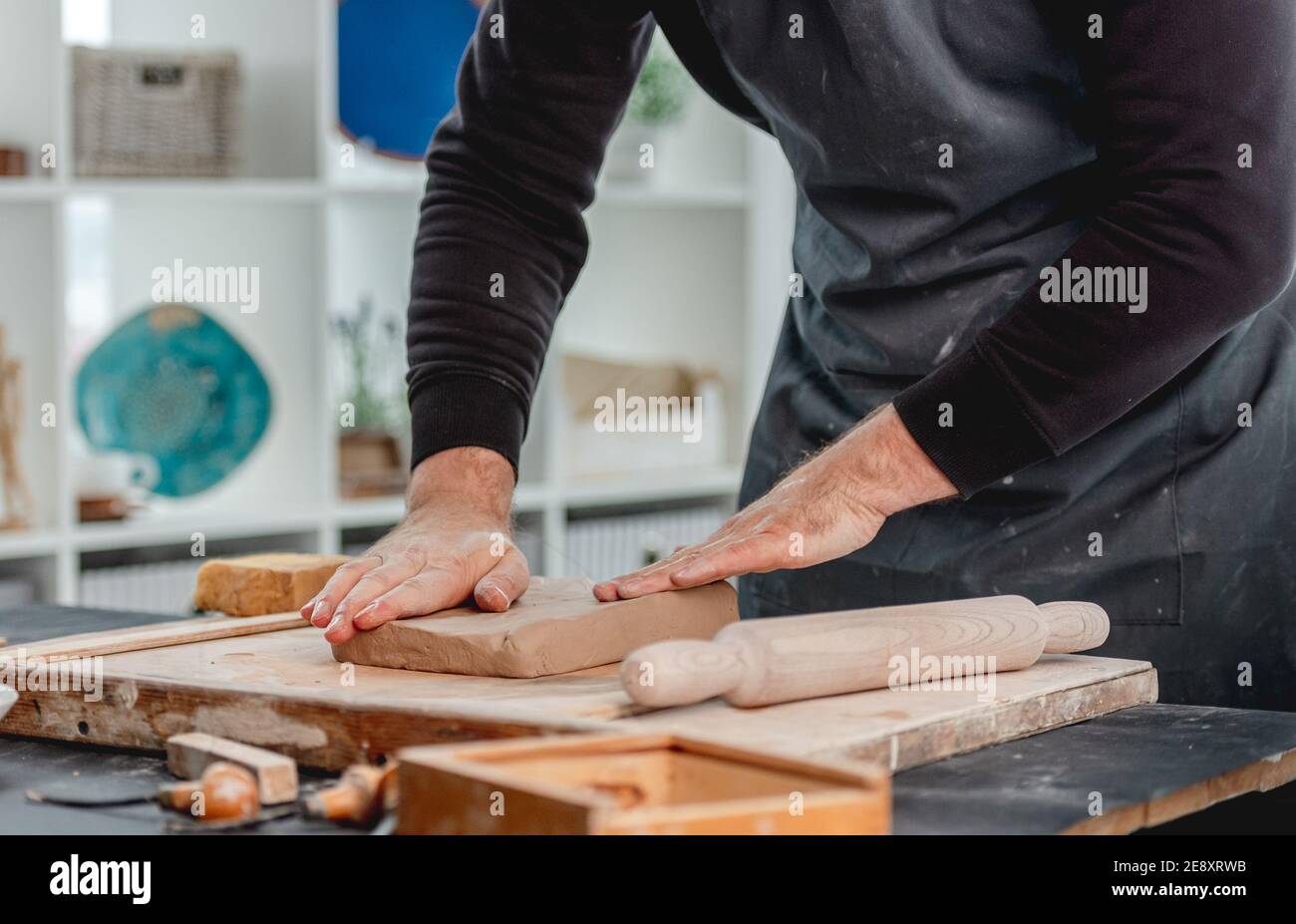 Man forming mold from pottery clay Stock Photo - Alamy