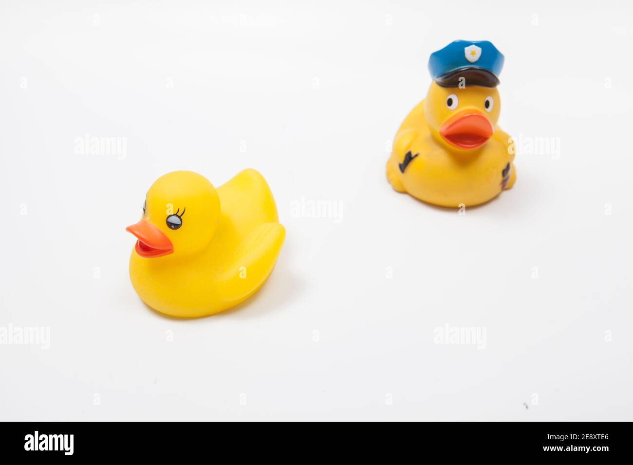 Rubber duck policeman chasing rubber duck criminal. Law enforcement ...