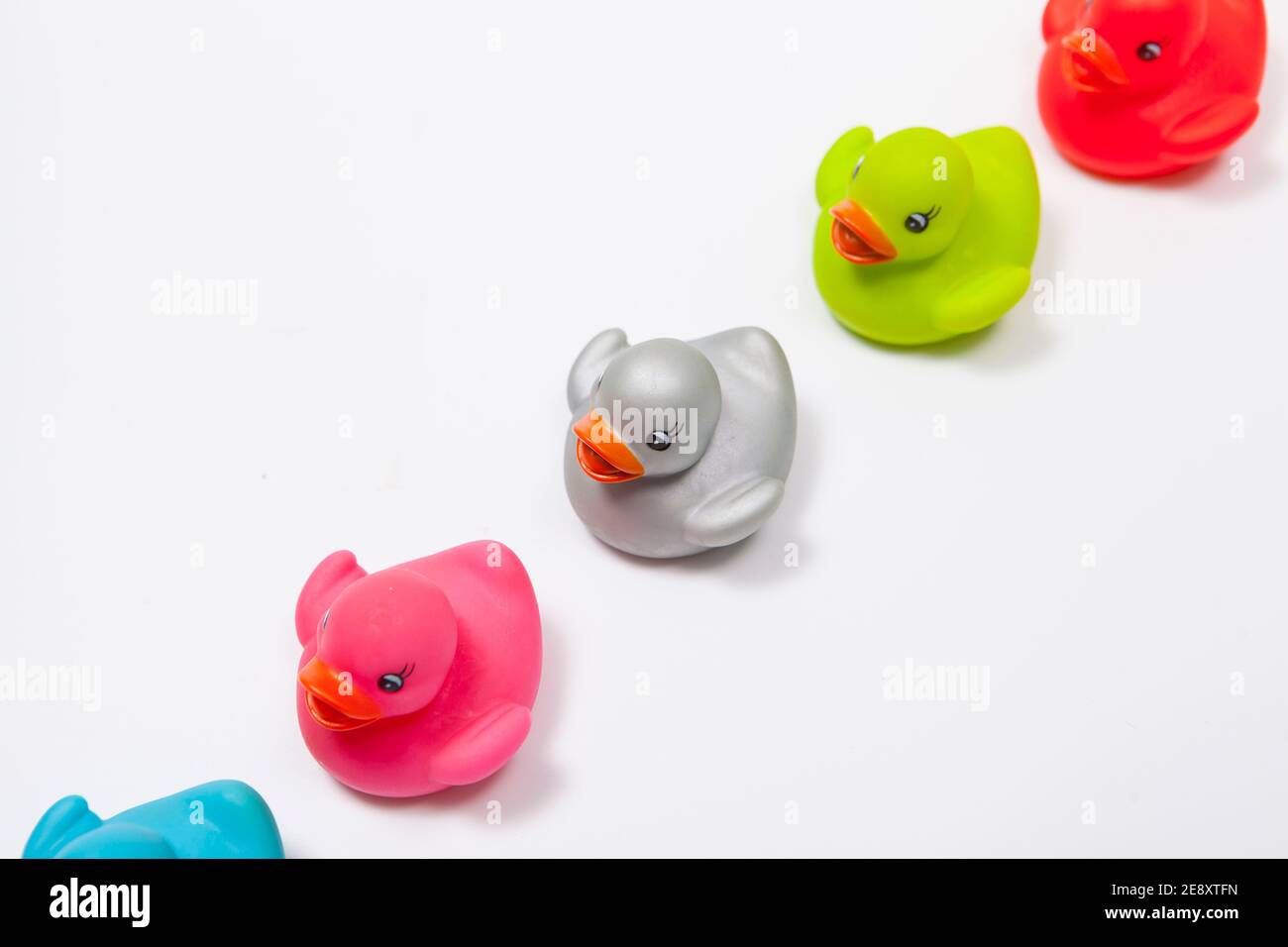 Colorful rubber ducks in a row isolated Stock Photo - Alamy
